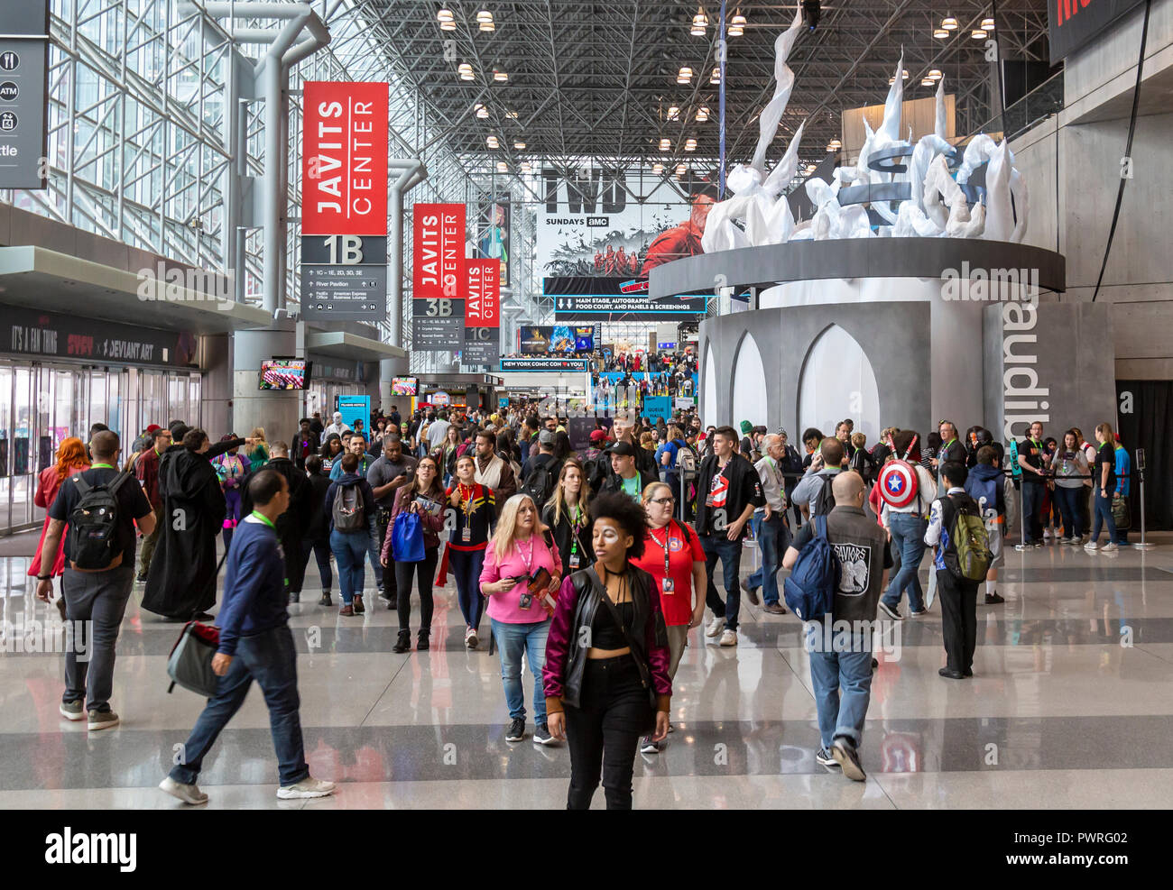 A crowd of visitors and fans to the New York Comic Con comic book and ...