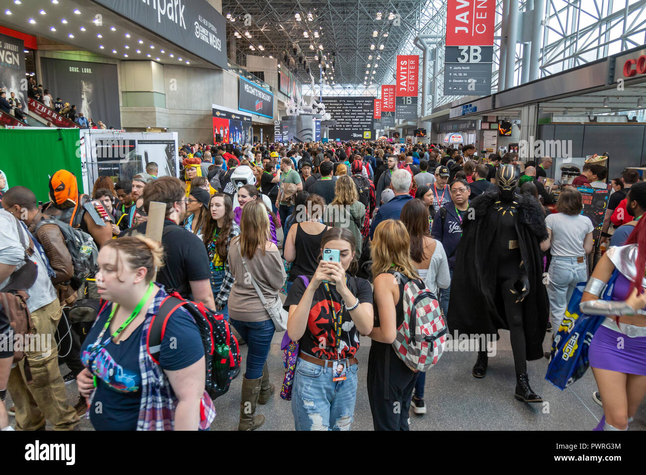 A crowd of visitors and fans to the New York Comic Con comic book and ...