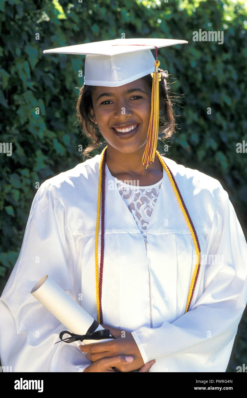 Happy female graduate posing with diploma Stock Photo - Alamy