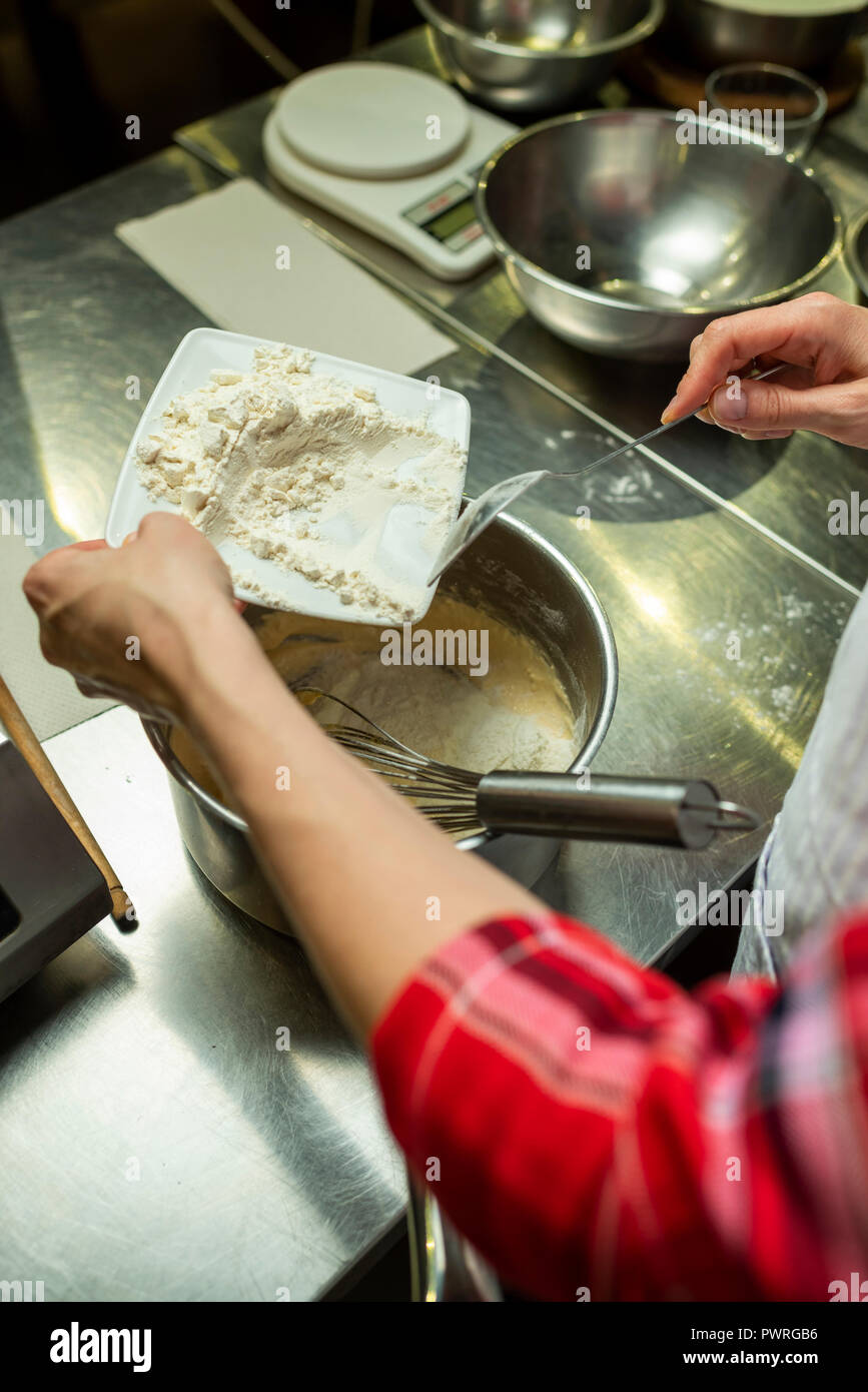 adding flour to the pan Stock Photo - Alamy
