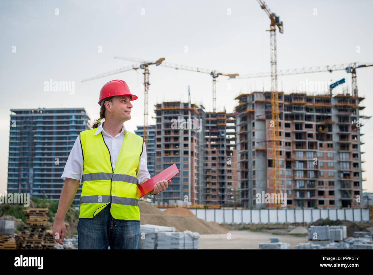 Engineer on a construction site working on housing project Stock Photo ...
