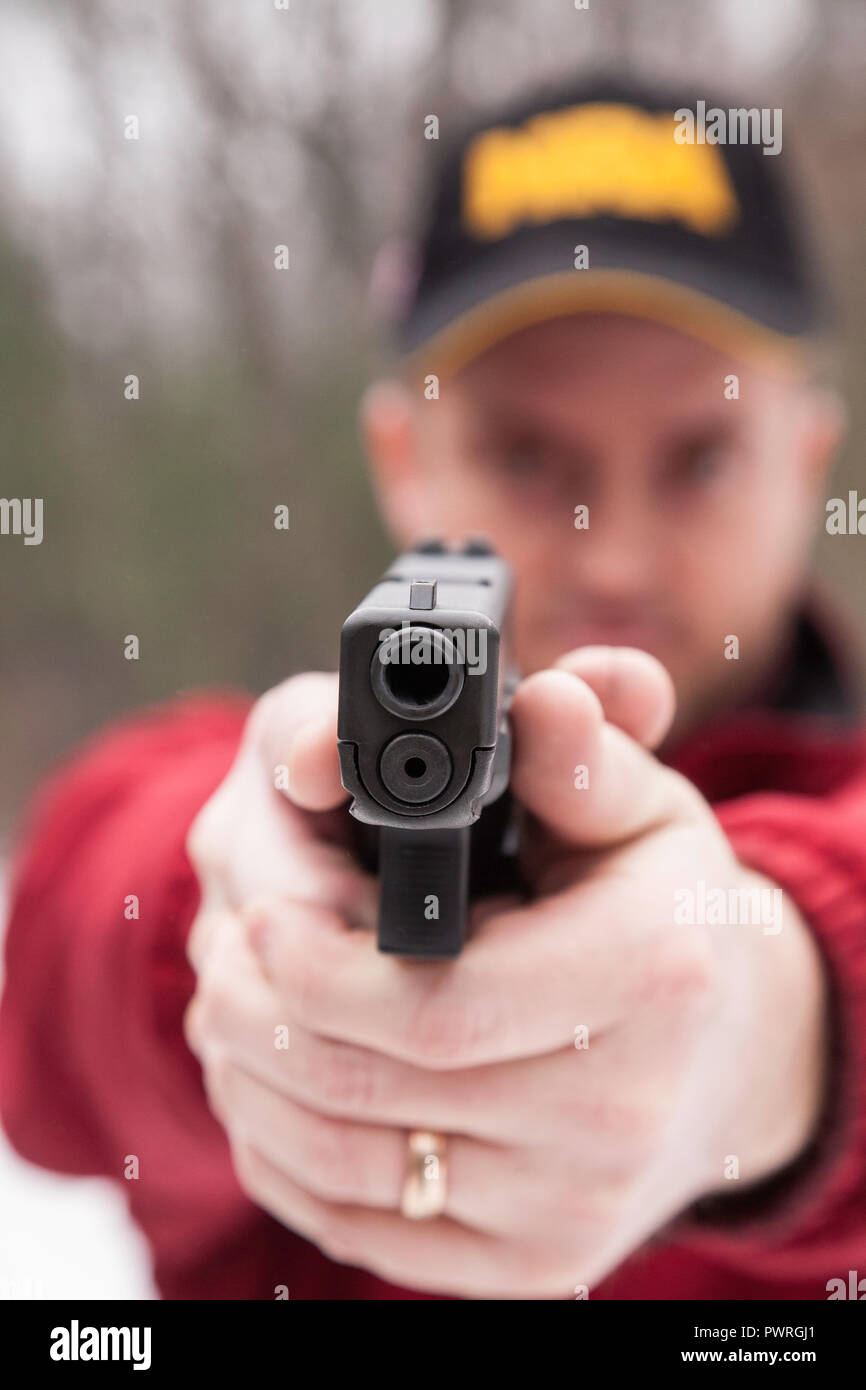 Middle aged man aiming a glock, USA Stock Photo - Alamy