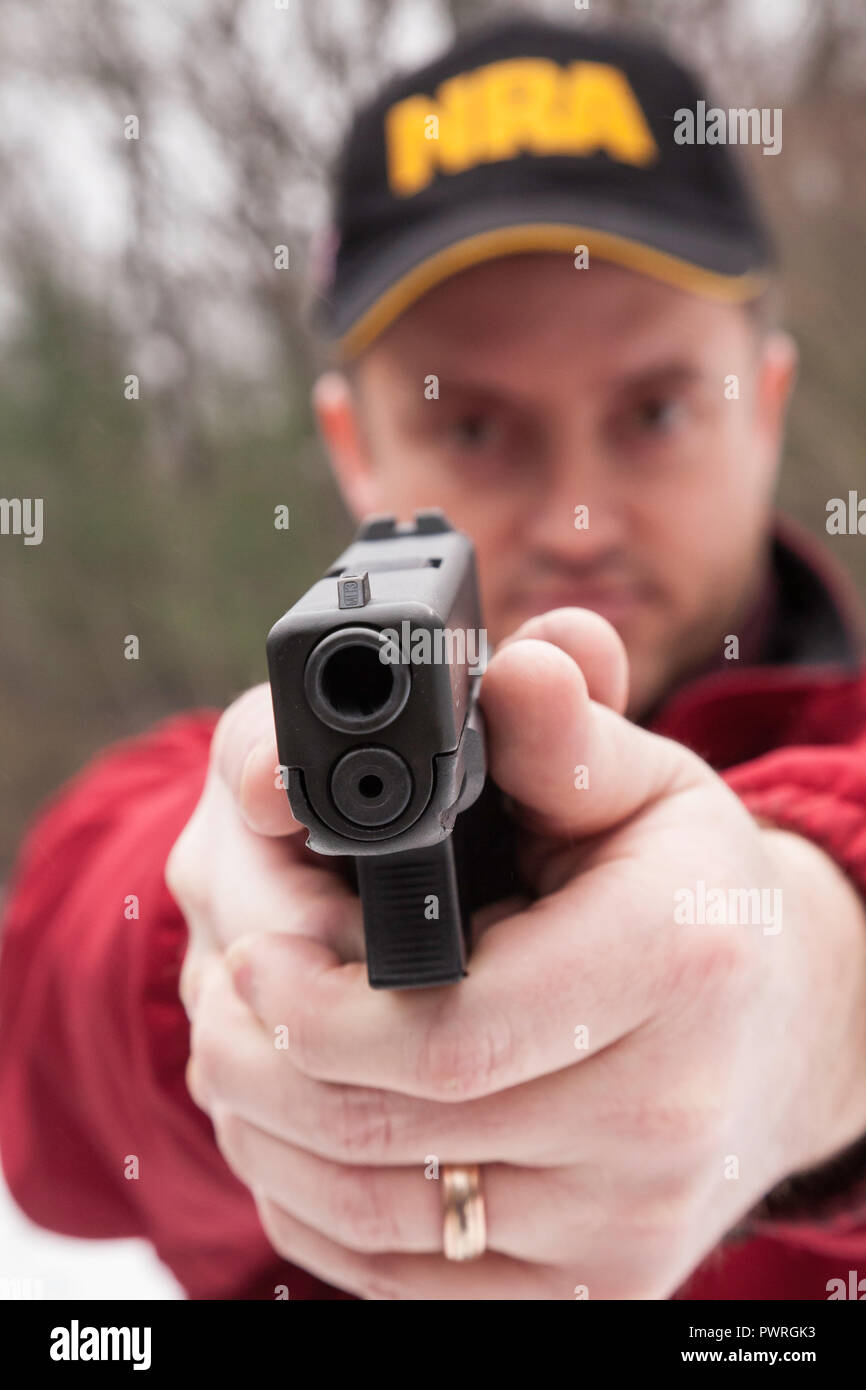Middle aged man aiming a glock, USA Stock Photo - Alamy