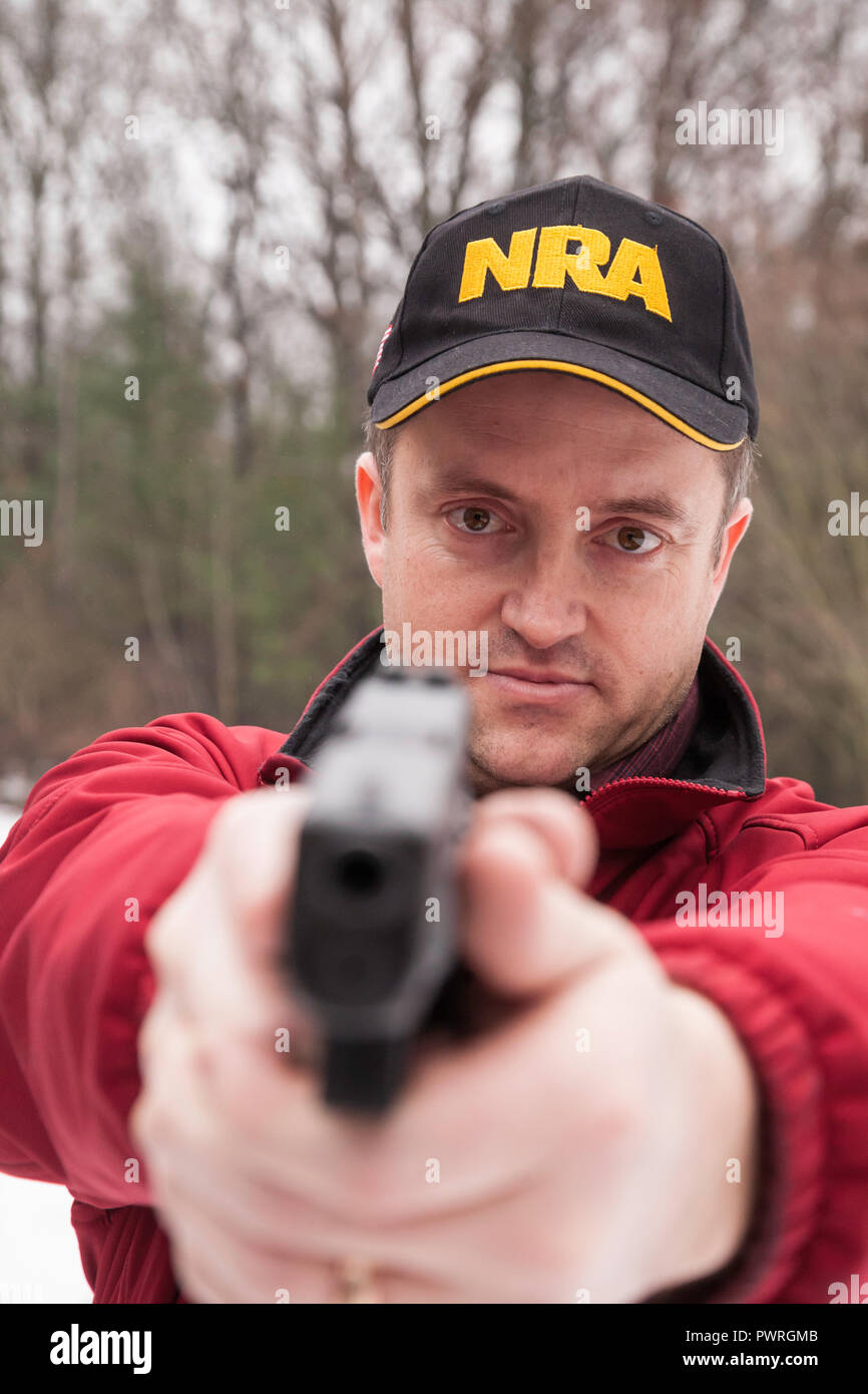 Middle aged man aiming a glock, USA Stock Photo - Alamy
