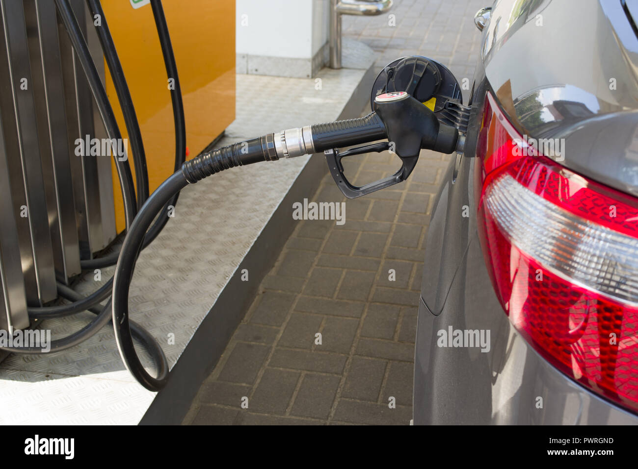 the gun for fuel is inserted into the gas tank of the car Stock Photo ...