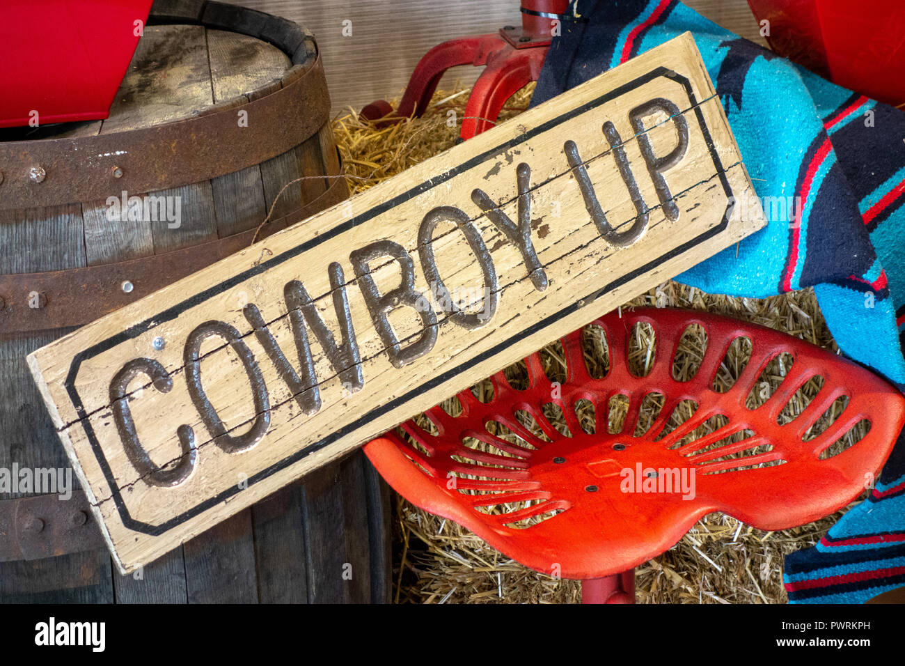 Western decor with Cowboy up sign and painted red vintage tractor seat ...