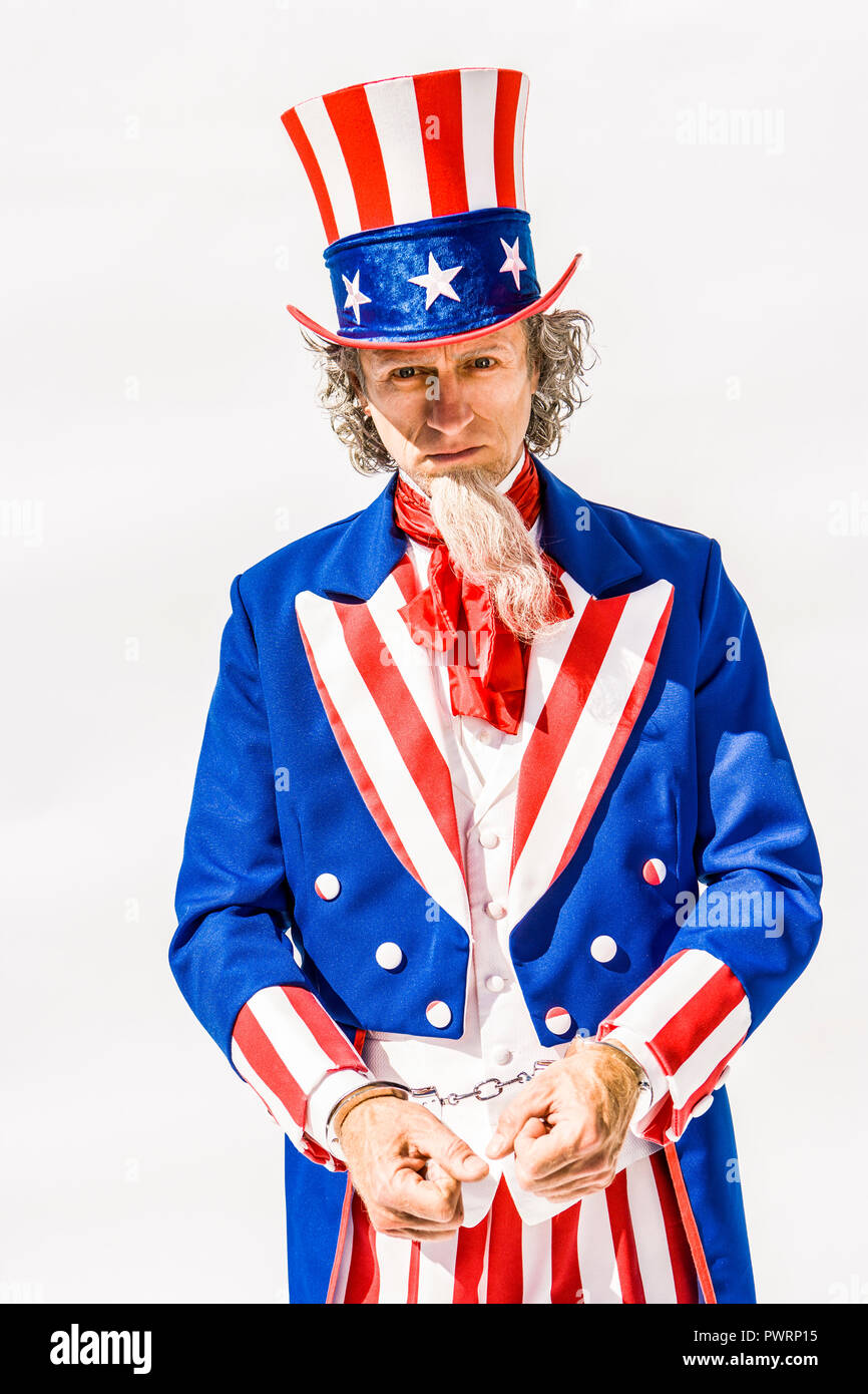 Uncle Sam character in handcuffs looking desperate Stock Photo - Alamy