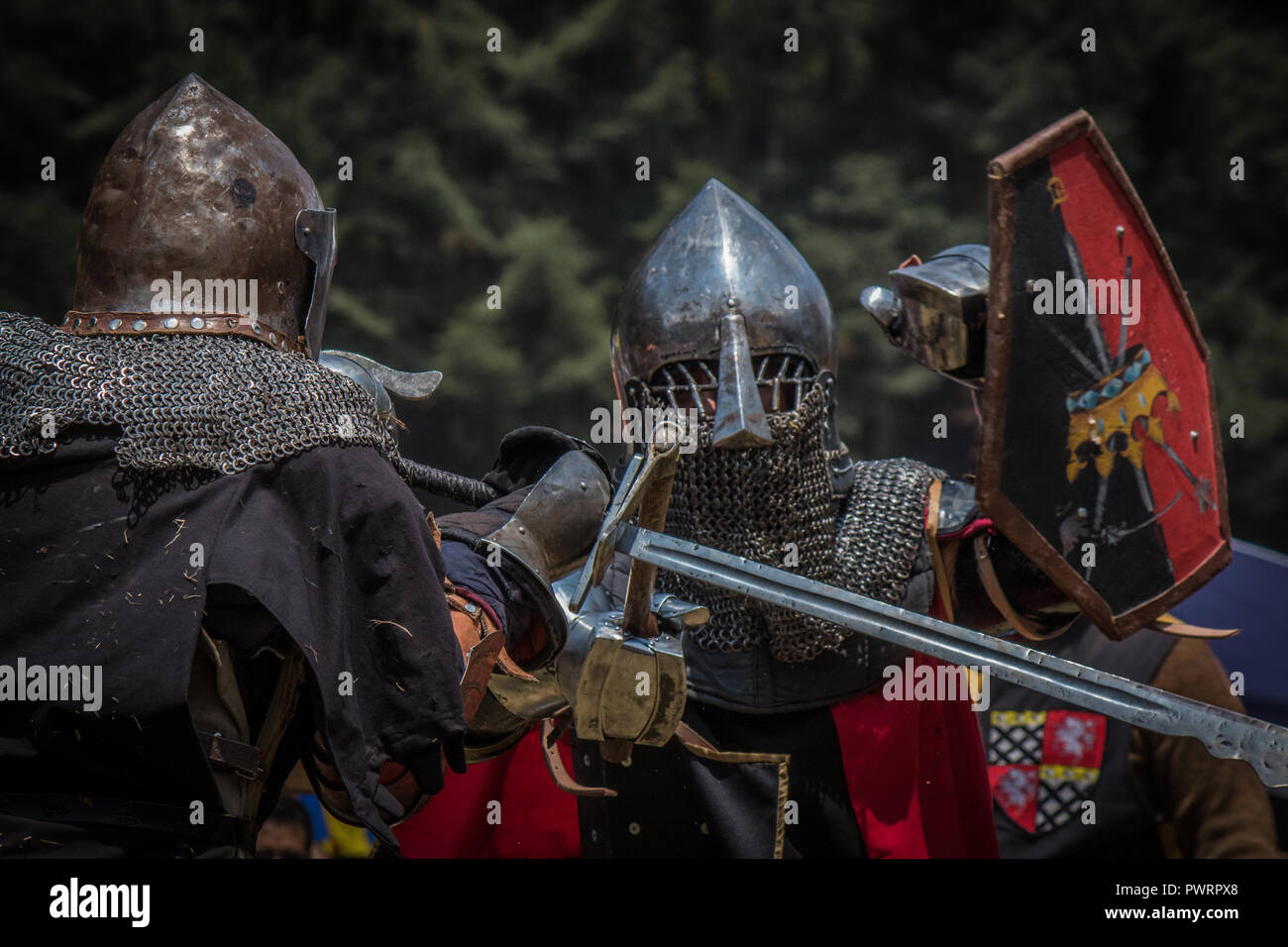 Medieval knights fighting with armor, swords and shields in festival ...