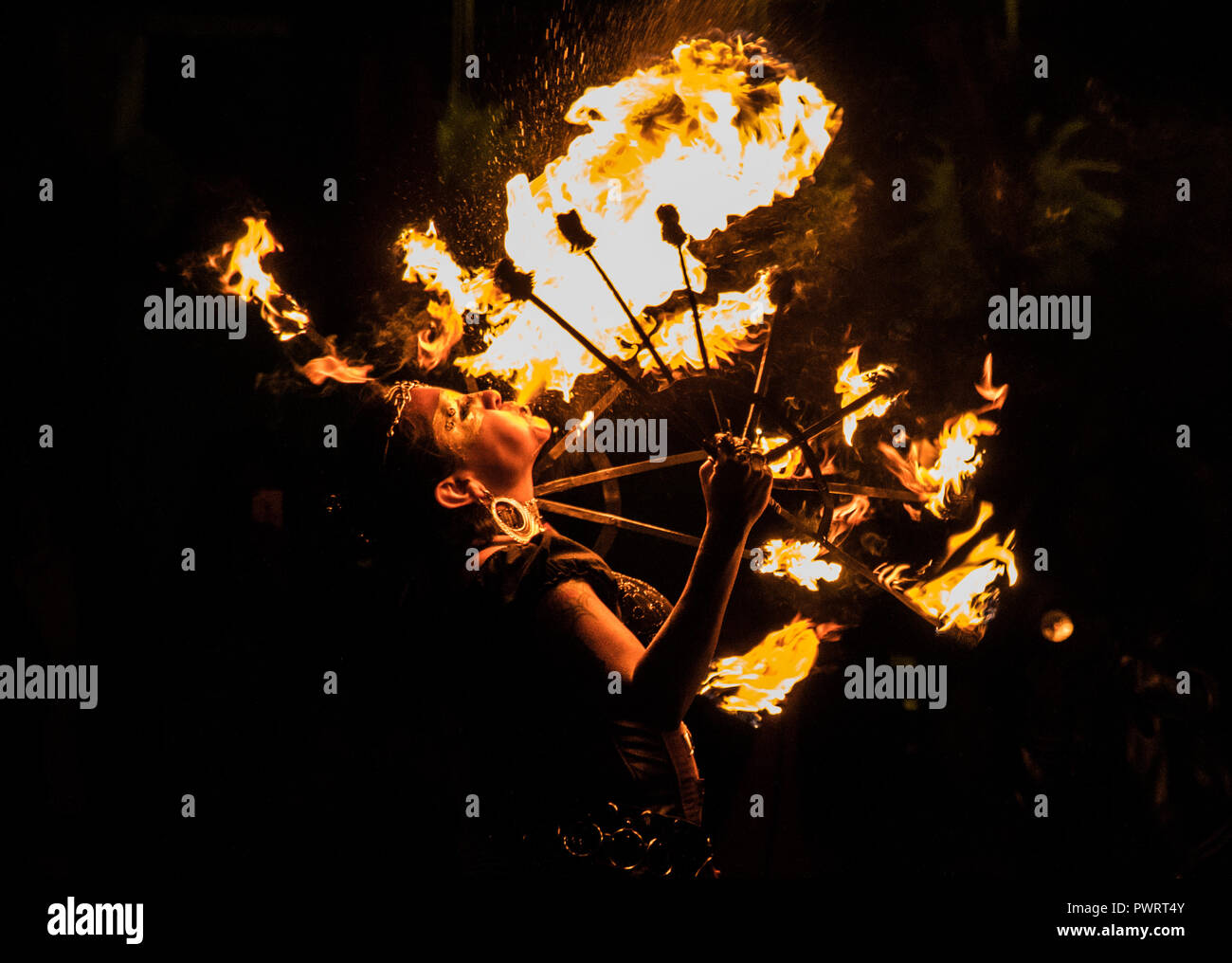 fire-eater in night show at medieval festival with black background ...