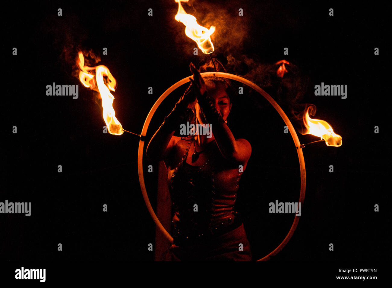 fire-eater, fire dancer with flaming hoop in night show at medieval ...