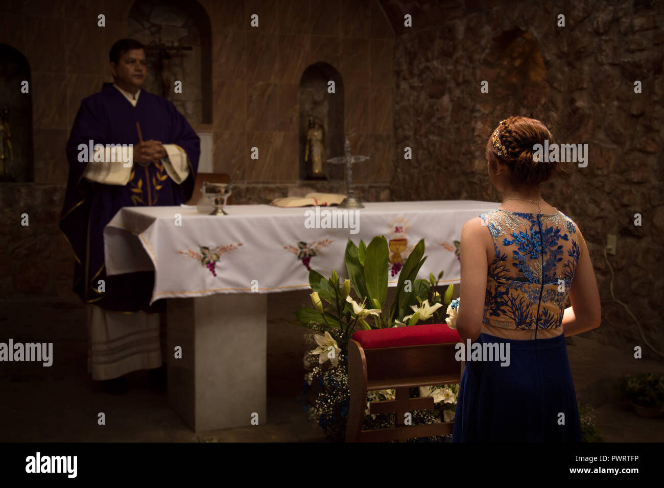 girl in blue lace dress receiving the gospel in stone church Stock ...