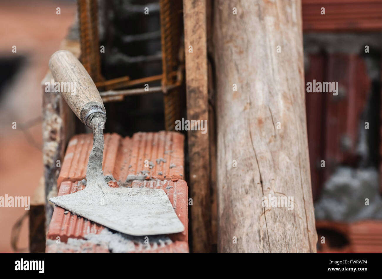 Brick trowel tool over a masonry wall. Construction background Stock ...