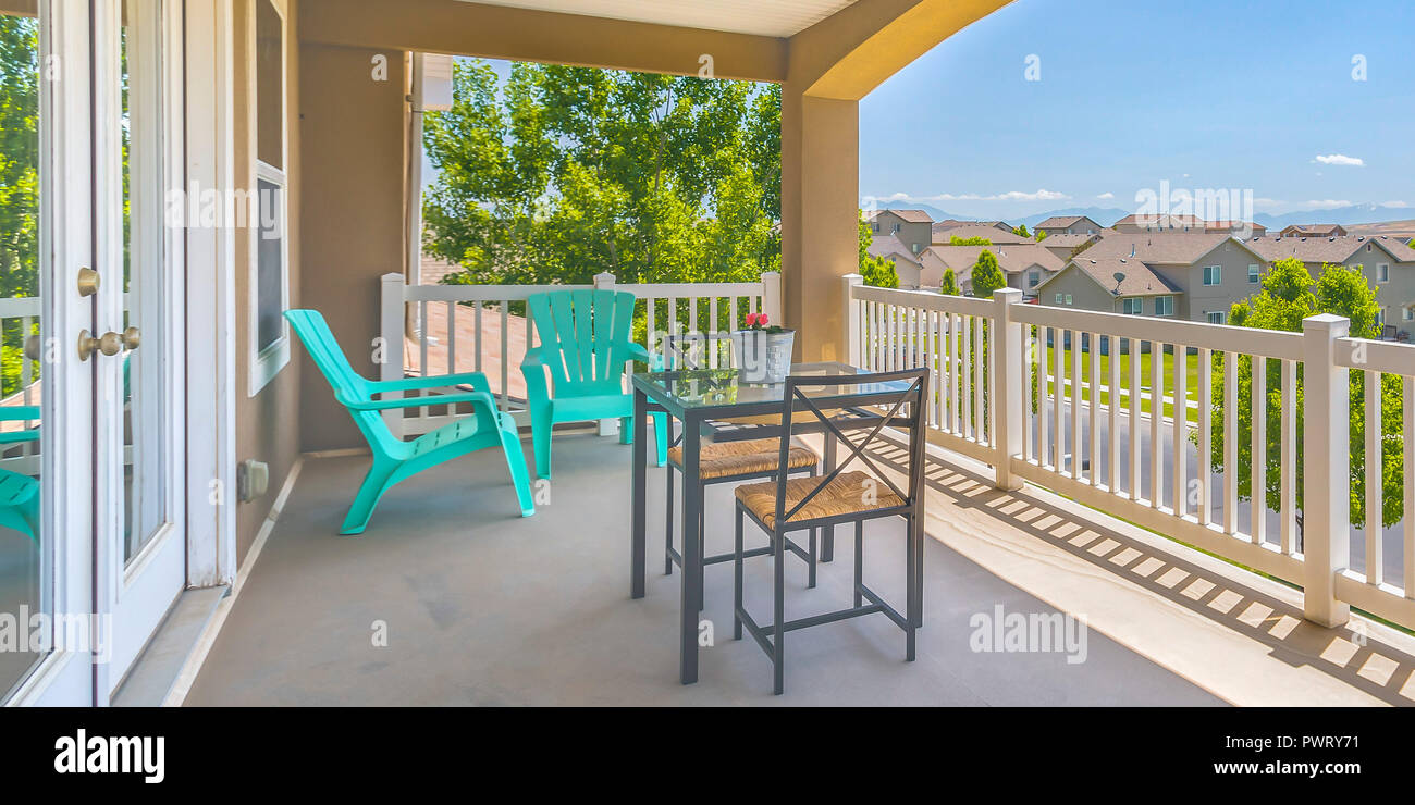 Balcony with furniture and view of homes and sky Stock Photo - Alamy