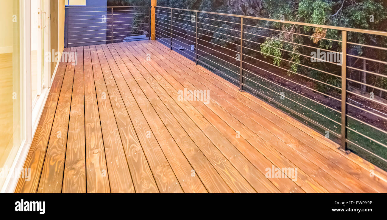 Balcony with wooden floor and glass door access Stock Photo - Alamy