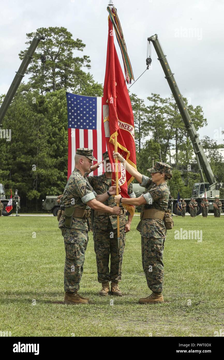 U.S. Marine Corps Lt. Col. Lauren S. Edwards, right, passes the Marine ...