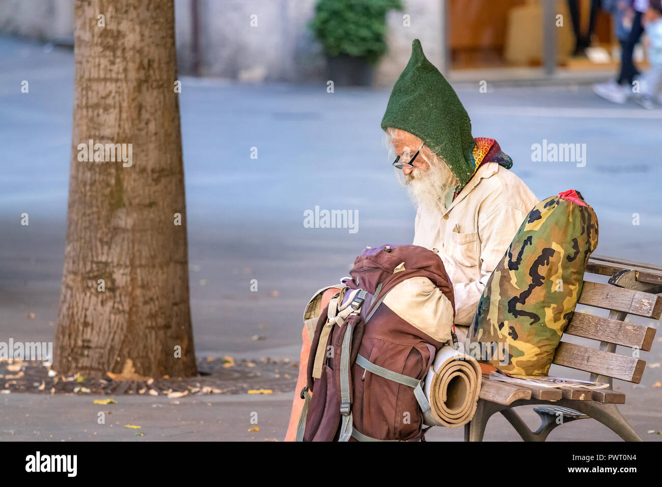 Ancona, Italy - September 27th, 2018: A senior man backpacker sitting ...