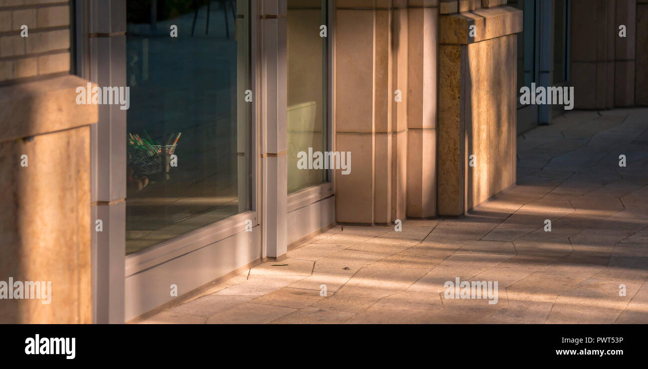 Glass doors reflecting sunlight on the street Stock Photo - Alamy