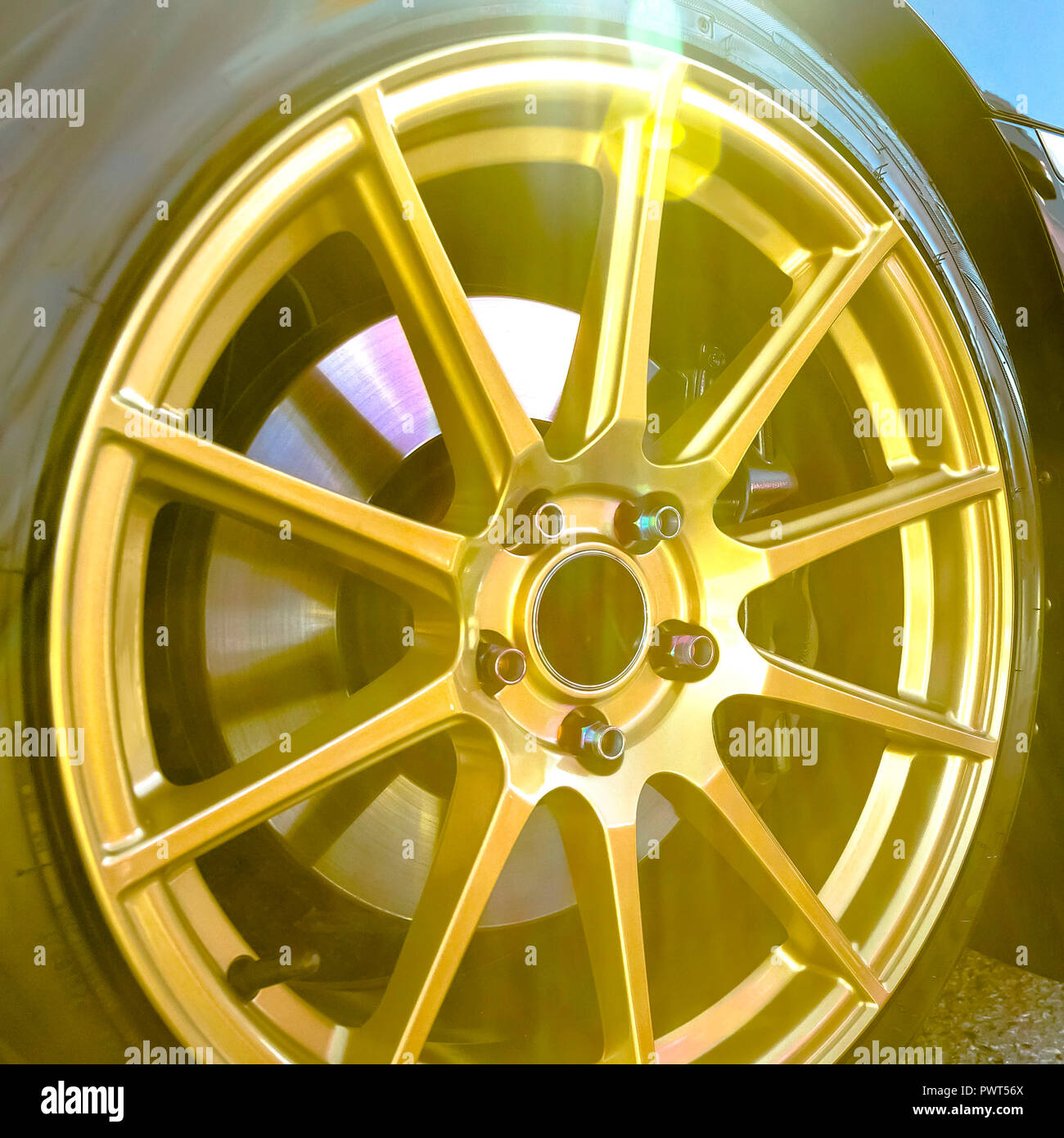 Golden wheel rim of a car on a bright sunny day Stock Photo - Alamy
