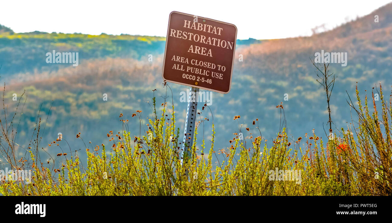 Habitat restoration area sign on a grassy mountain Stock Photo - Alamy