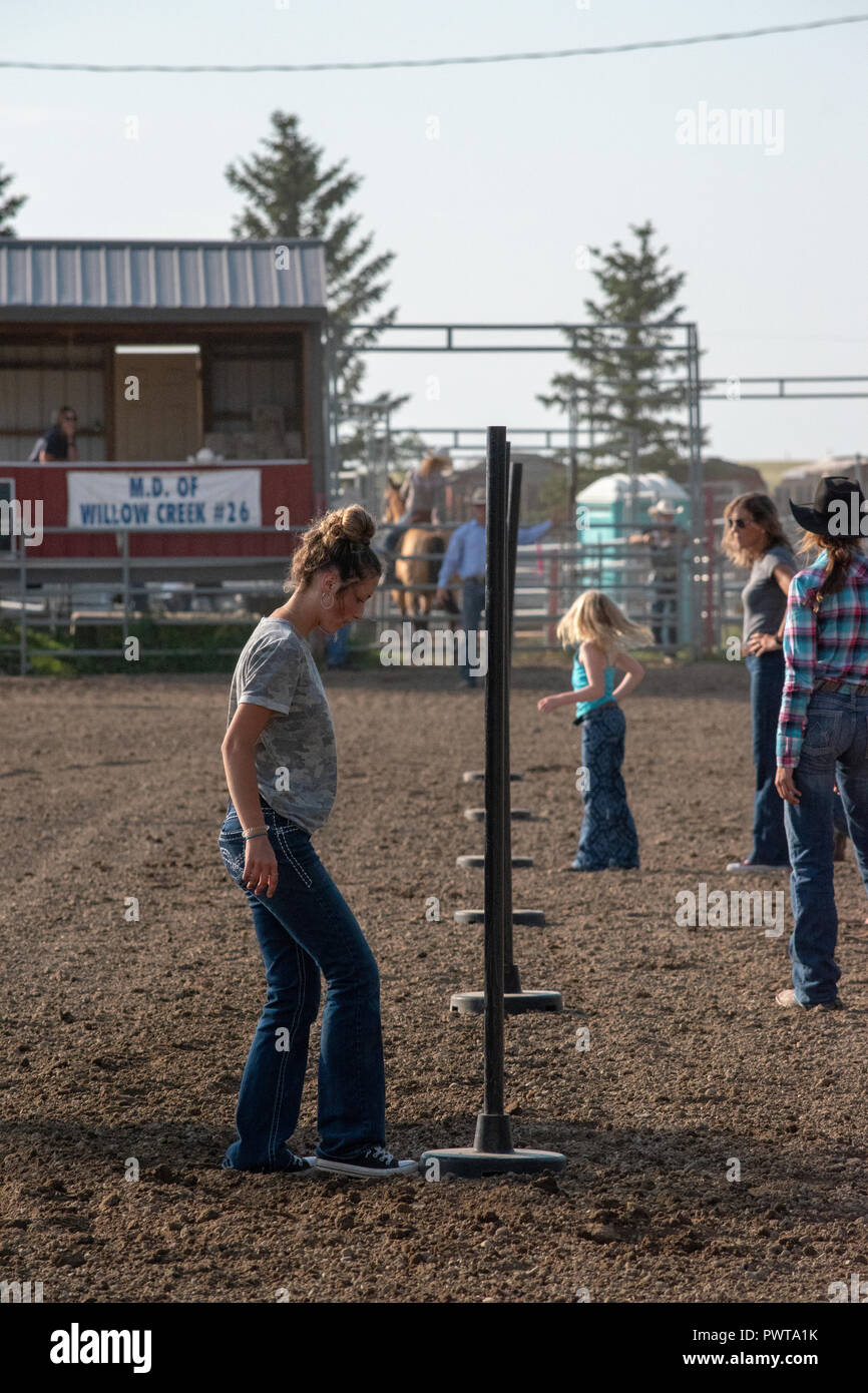 Girls correct the poles for the pole bending competition at the Nanton ...