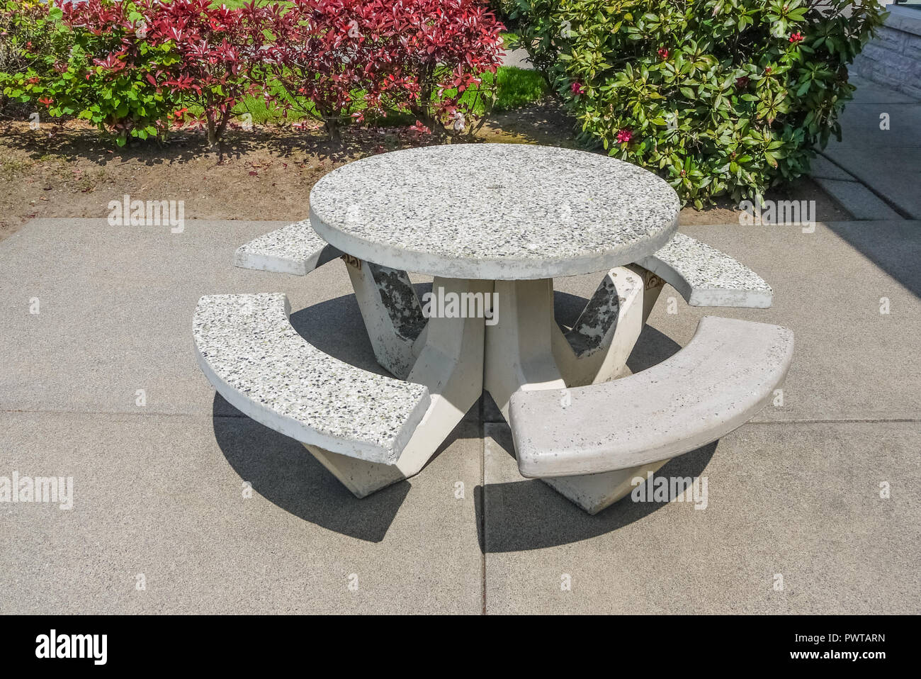 Recreation area with picnic table on concrete pavement in a park Stock ...