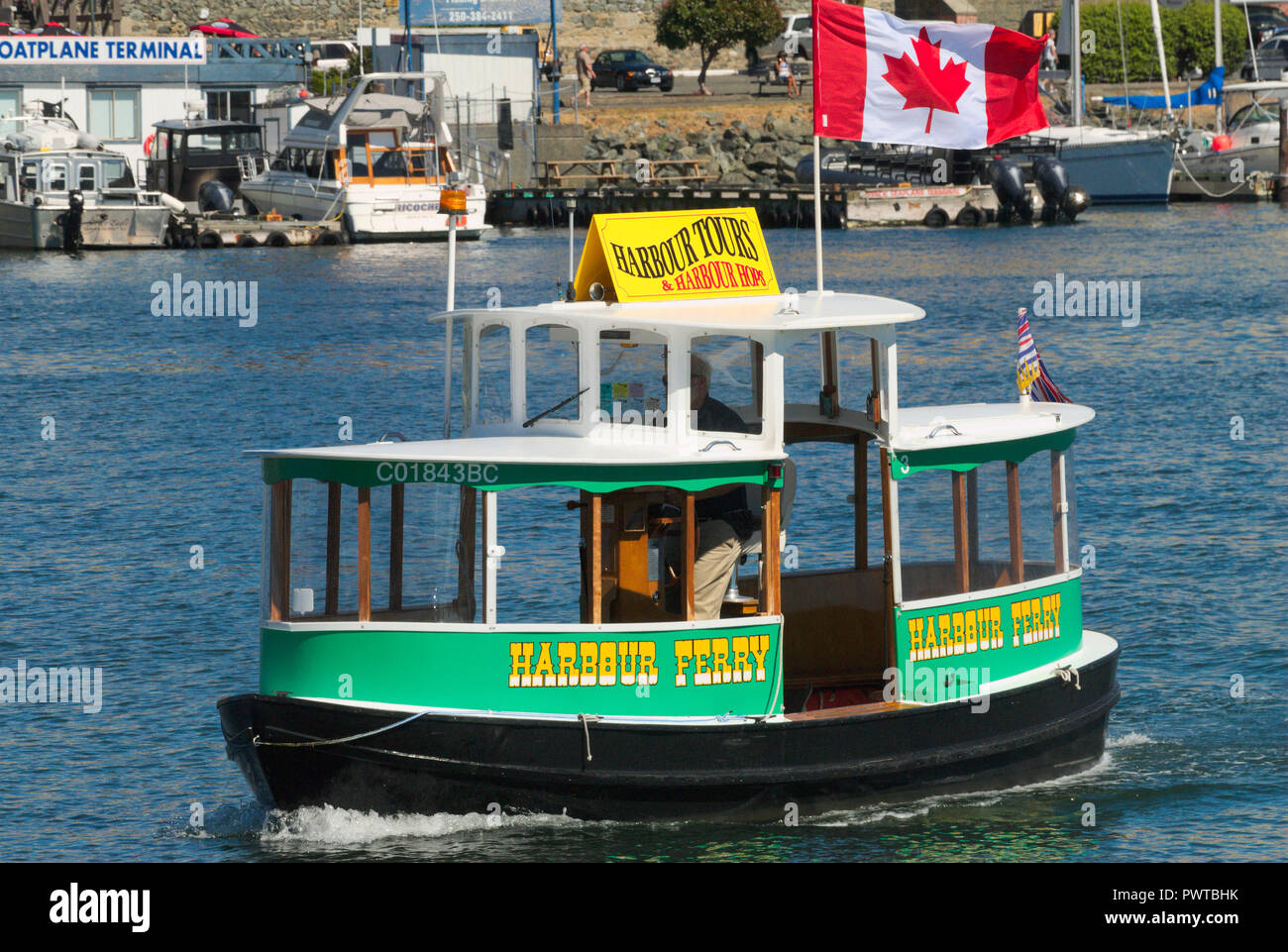 A small ferry plies the waters of the inner harbor in Victoria, British ...