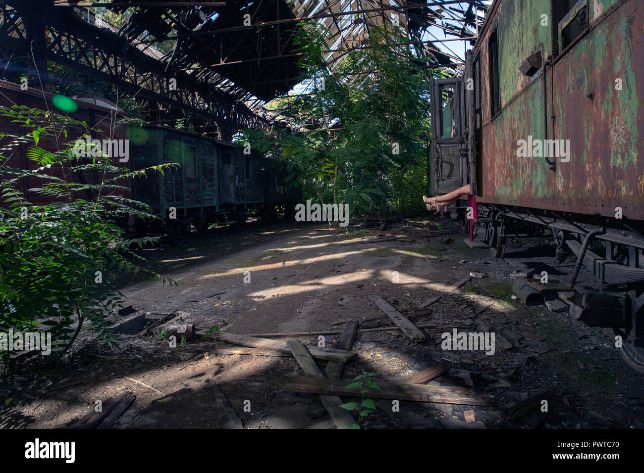 Showing her legs out of the abandoned train in abandoned Istvántelek ...