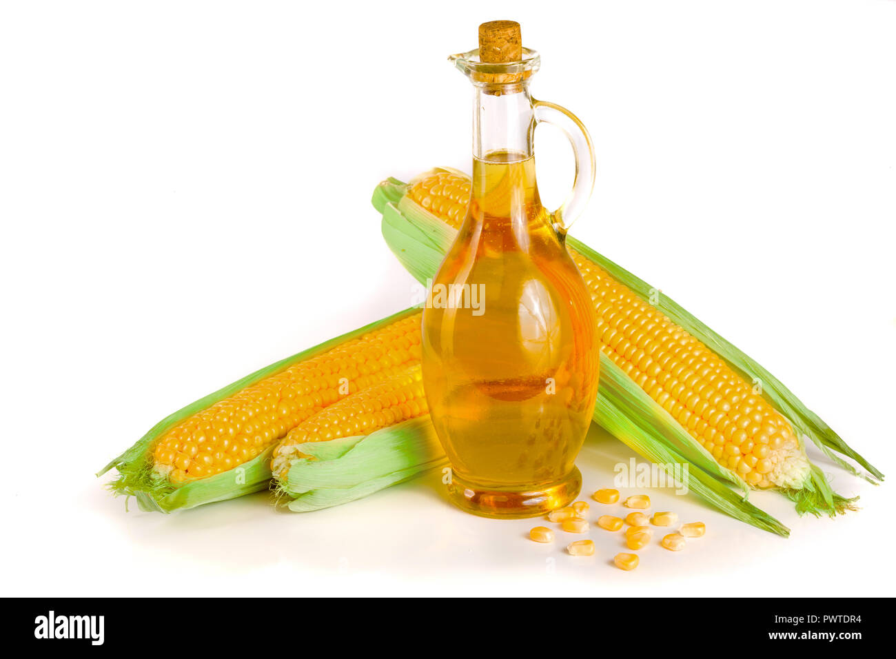 Corn oil in decanter, fresh corn cobs and grains isolated on white ...