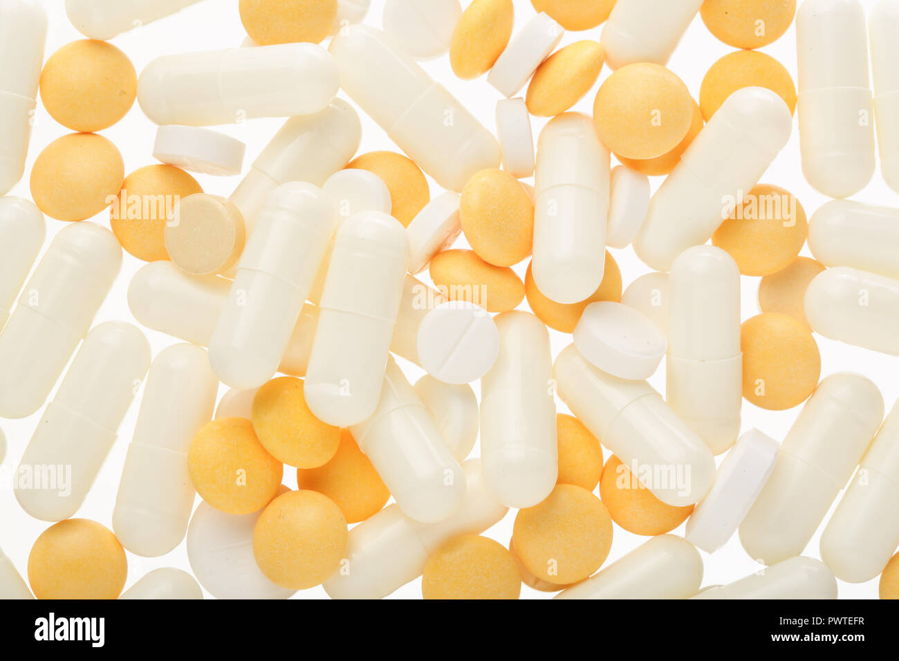 white and yellow pill capsule isolated on white background. Top view ...