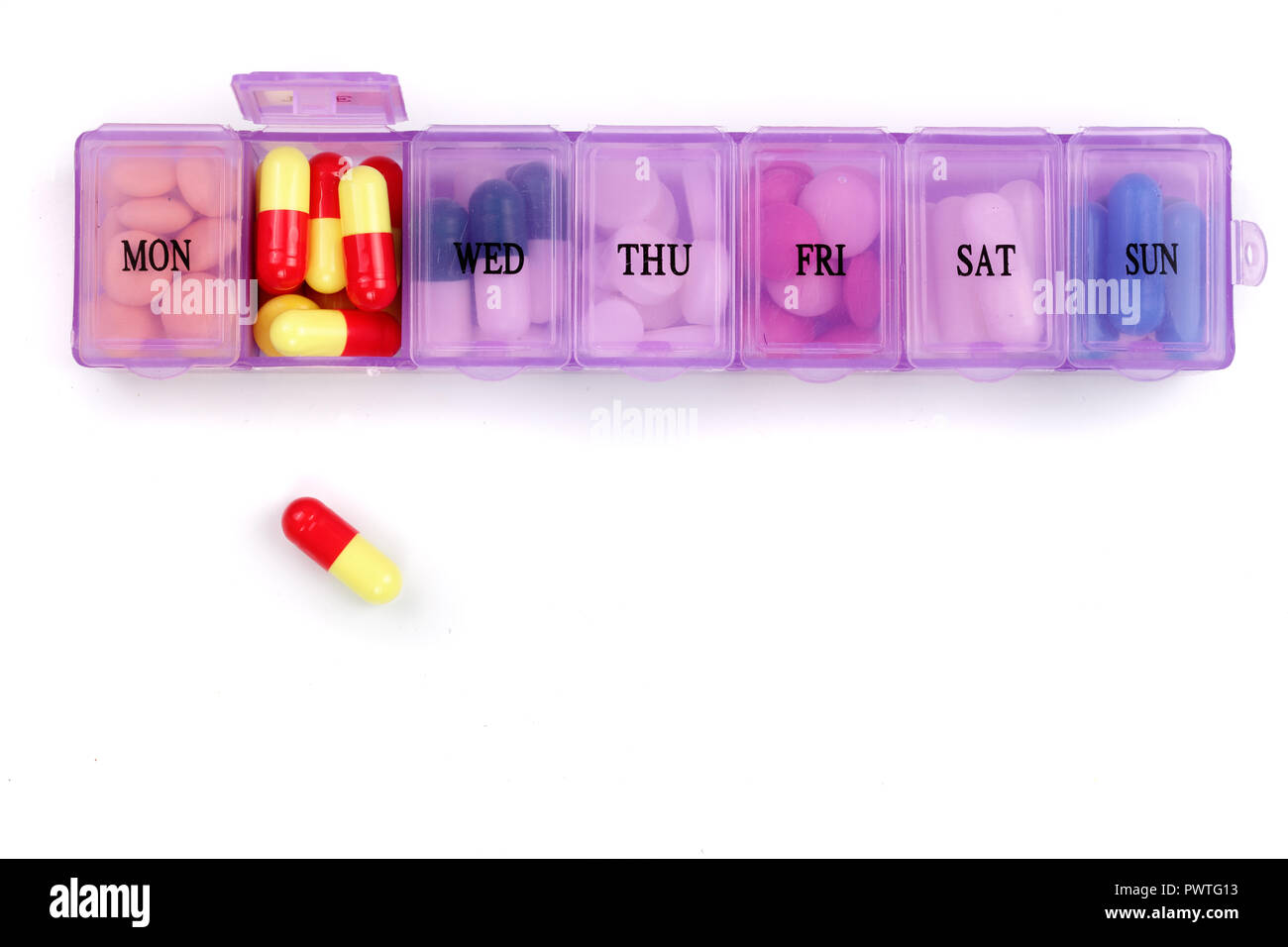 Daily pill box with medical pills isolated on white background with ...