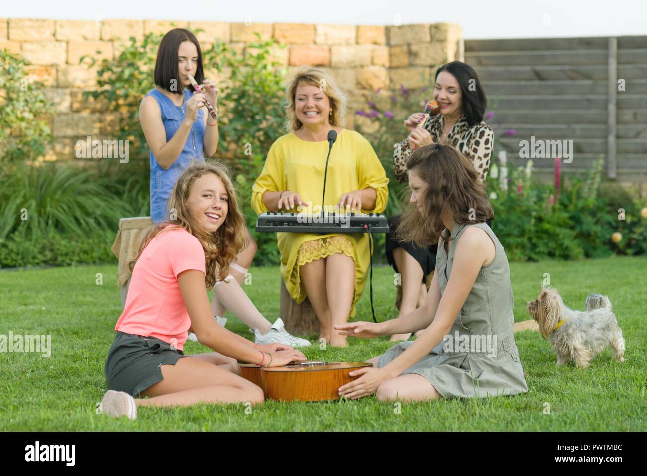 The family is having fun, two mothers with teenage daughters are ...