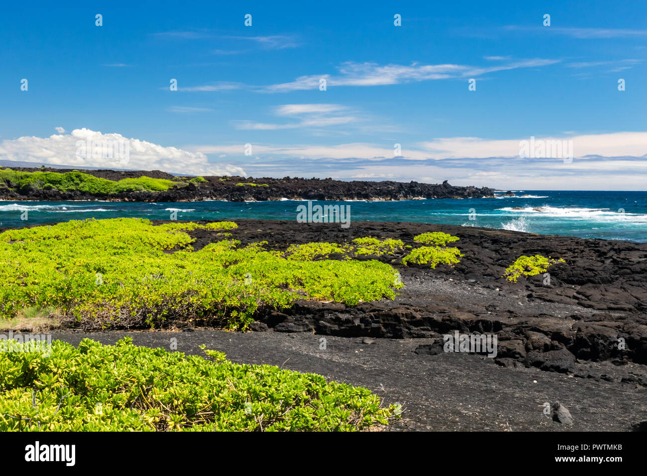 Black Sand beach on the Big Island of Hawaii; black volcanic rock and ...