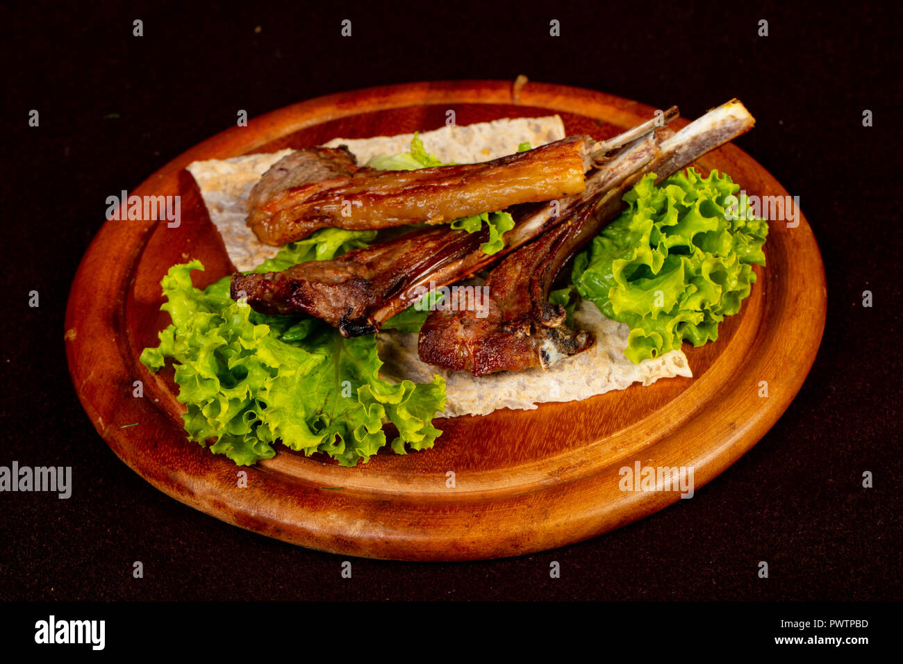 Grilled rack of lamb served salad leaves Stock Photo - Alamy