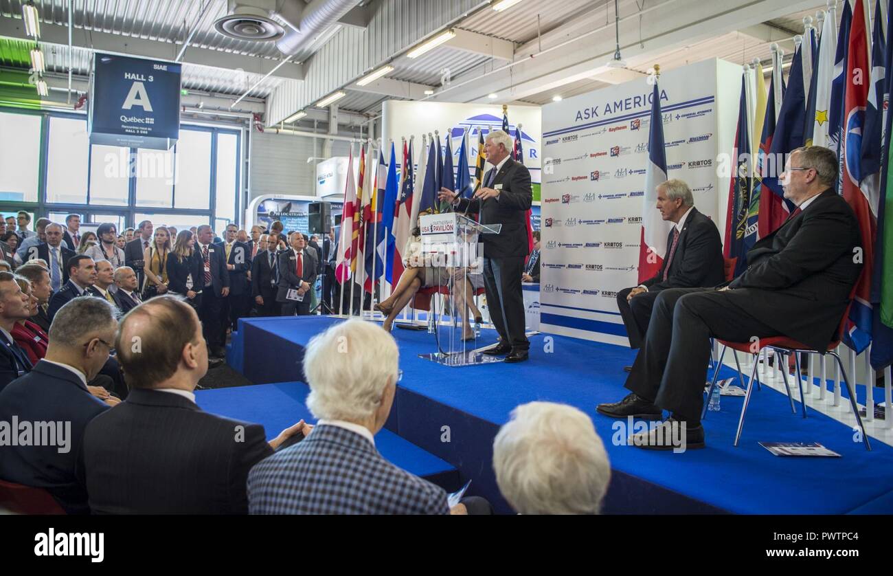 Deputy Secretary of Defense Bob Work listens to Dave Melcher, president ...