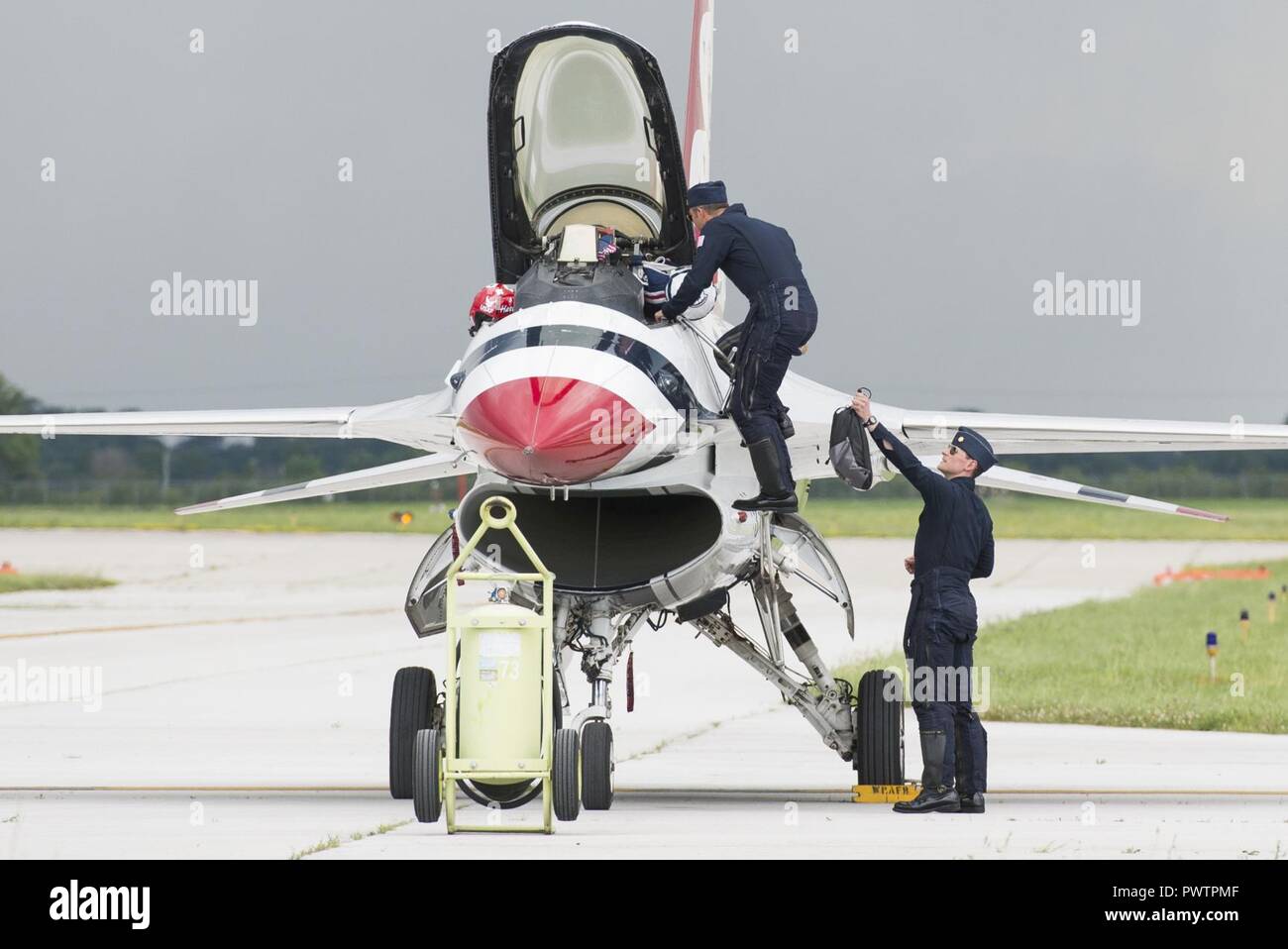 U.S. Air Force Maj. Nate Hoffman, Thunderbird 3, hands an item from his ...