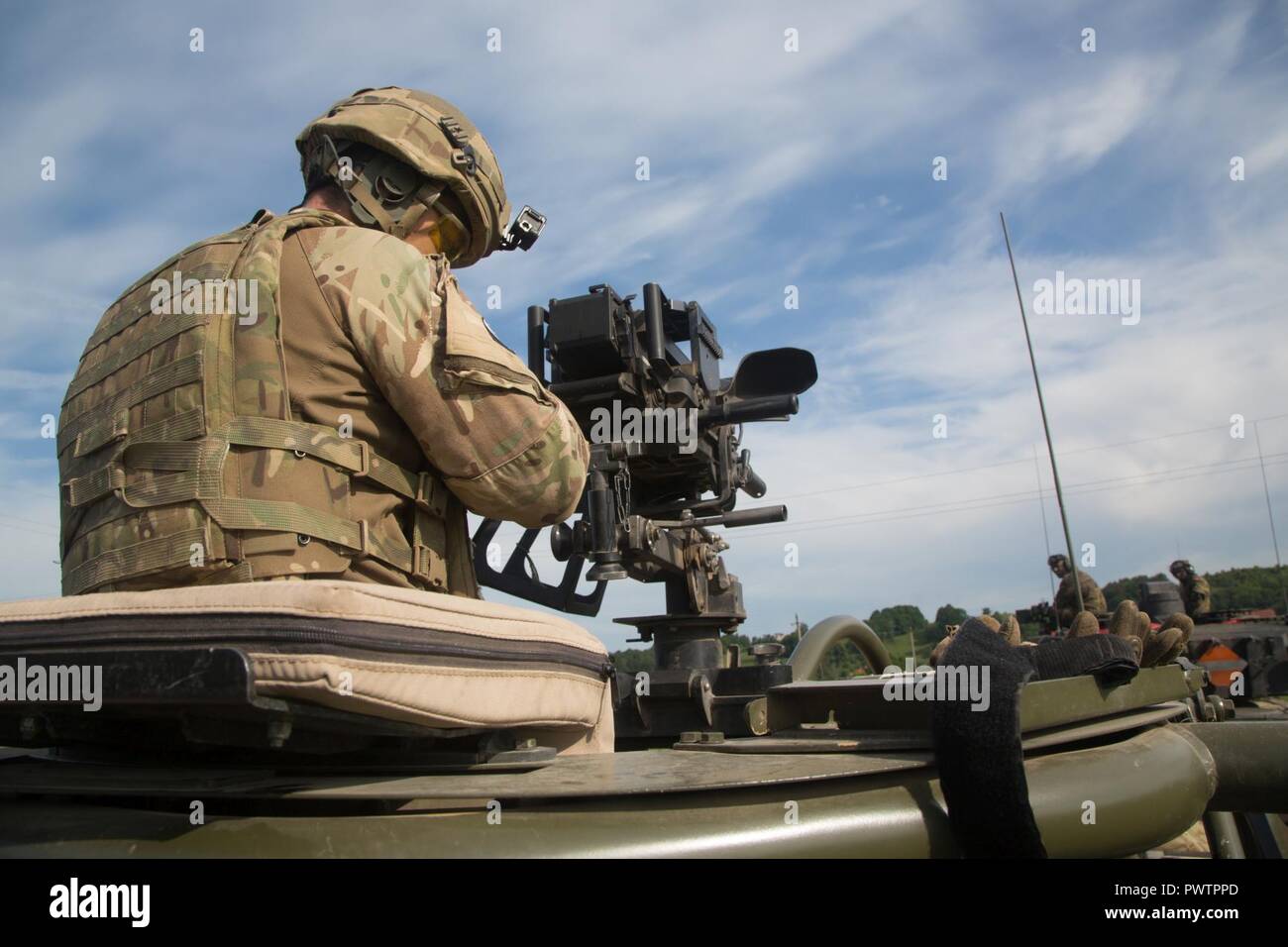 U.K. soldier Cpl. Wayne Pennington sits in the gunner seat of a ...