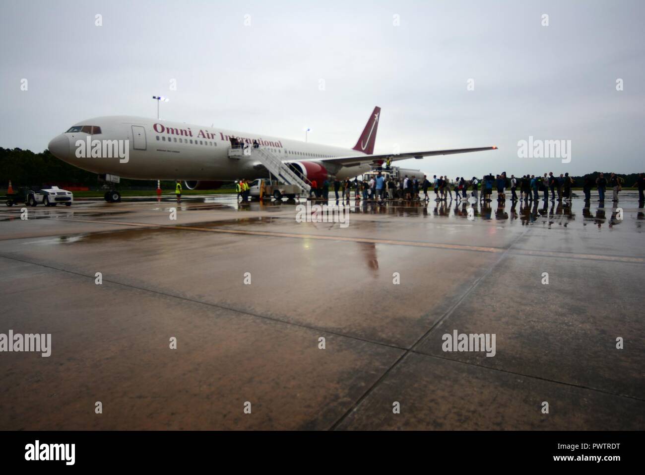 Airmen of the 125th Fighter Wing line up to board the aircraft taking ...