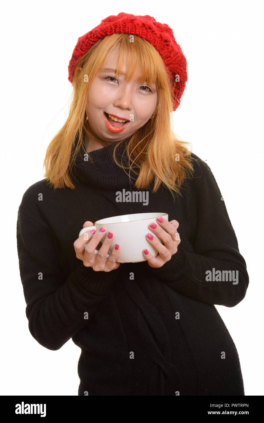 Young happy Asian woman smiling and holding coffee cup Stock Photo - Alamy