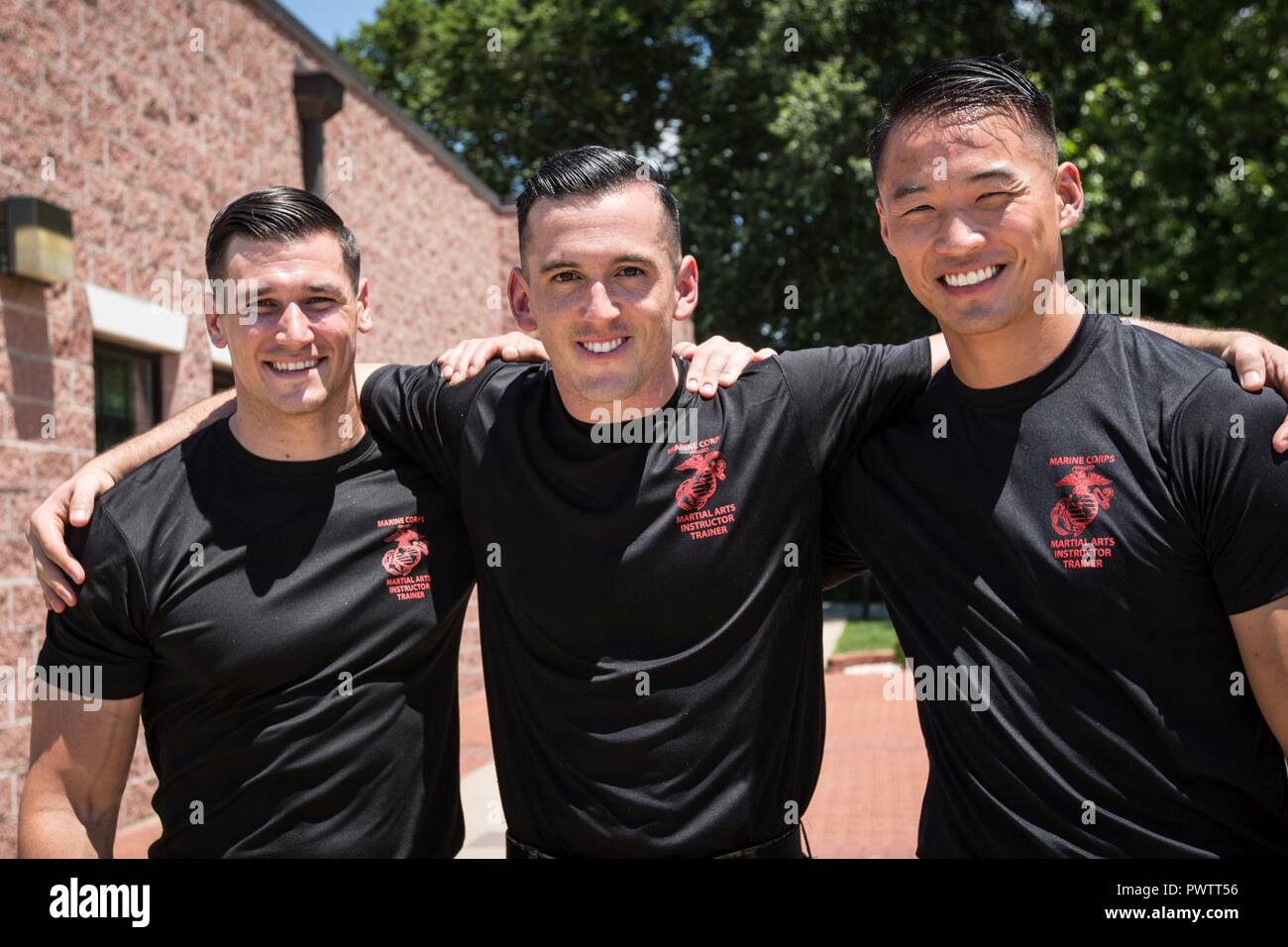 The Martial Arts Center of Excellence staff pose for a photo outside ...