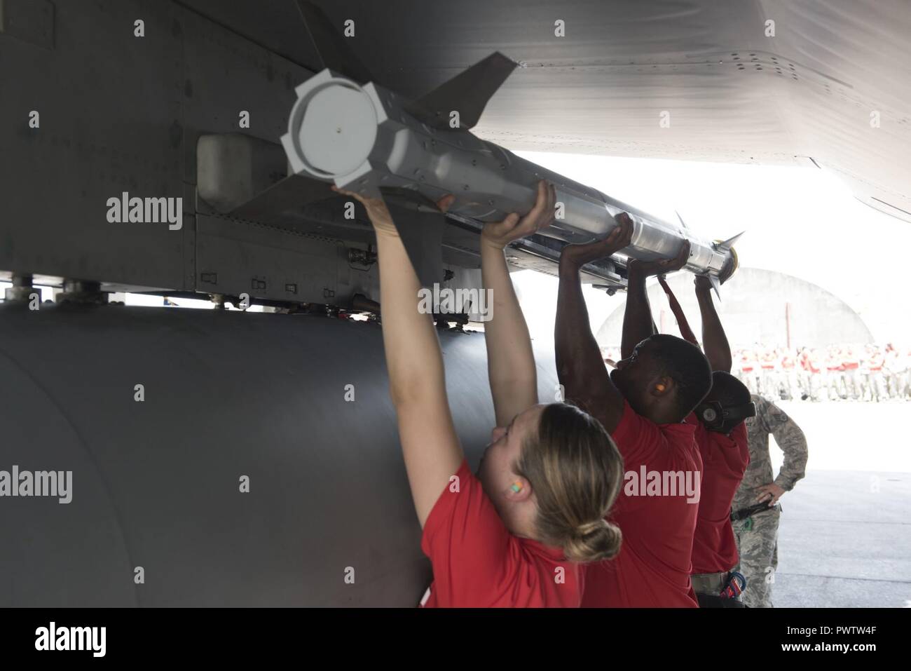 A weapons load team from the 67th Aircraft Maintenance Unit loads an ...