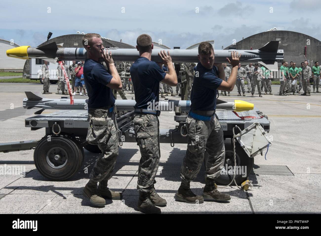 A U.S. Air Force weapons load team from the 44th Aircraft Maintenance ...