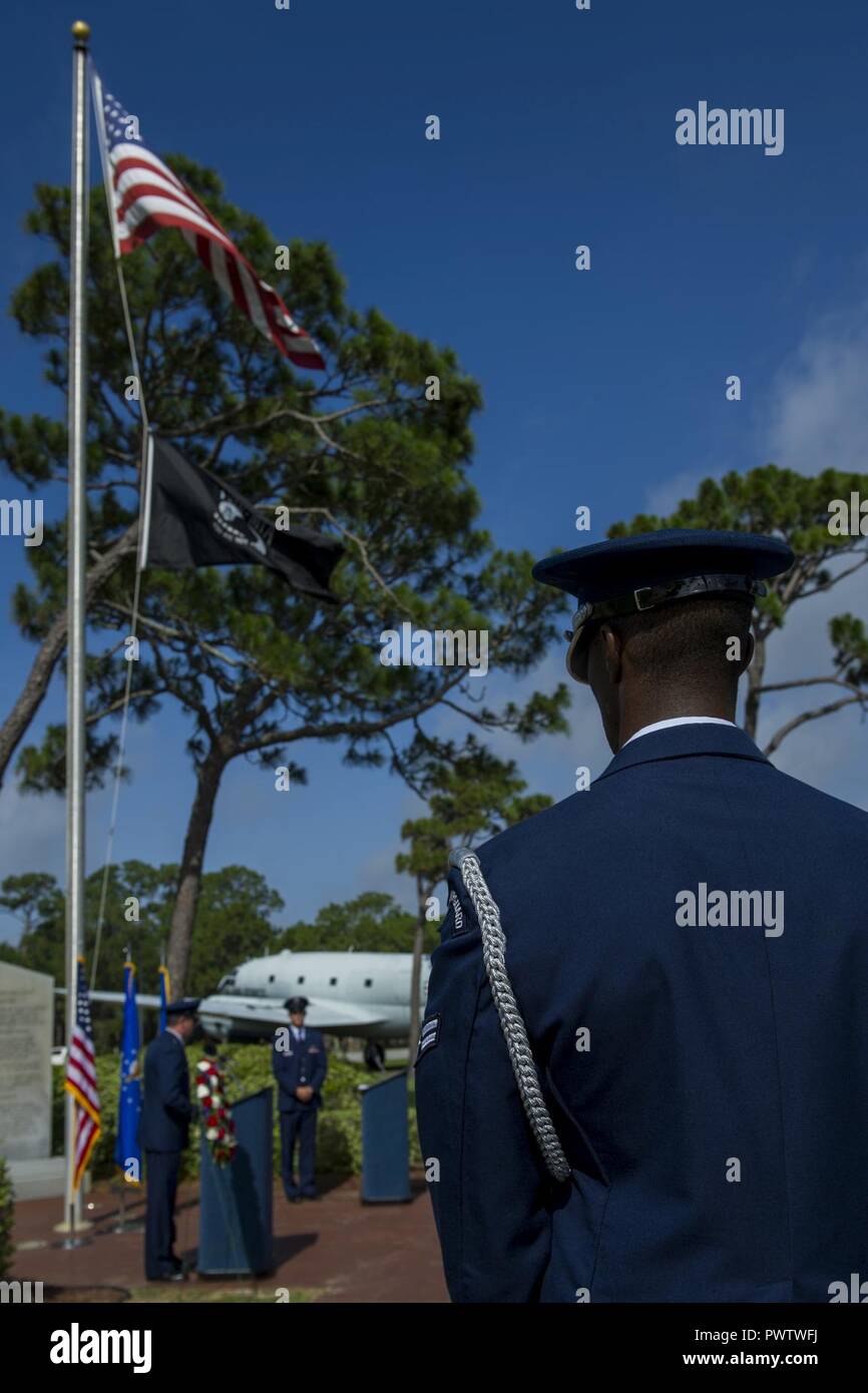 A member of the Hurlburt Field Honor Guard pays respects during the ...