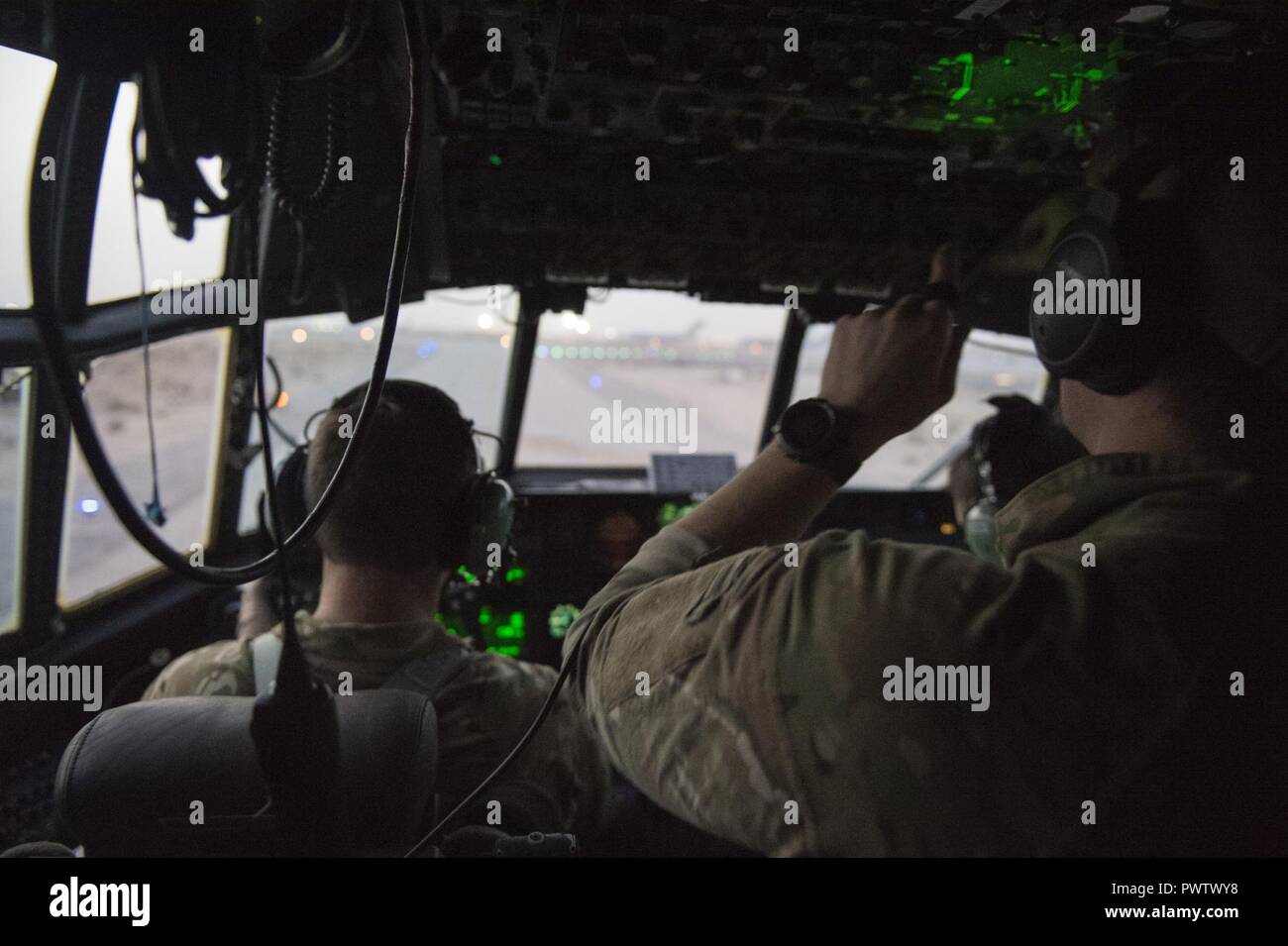 U.S. Air Force MC-130 pilots prepare for a resupply airdrop over an ...