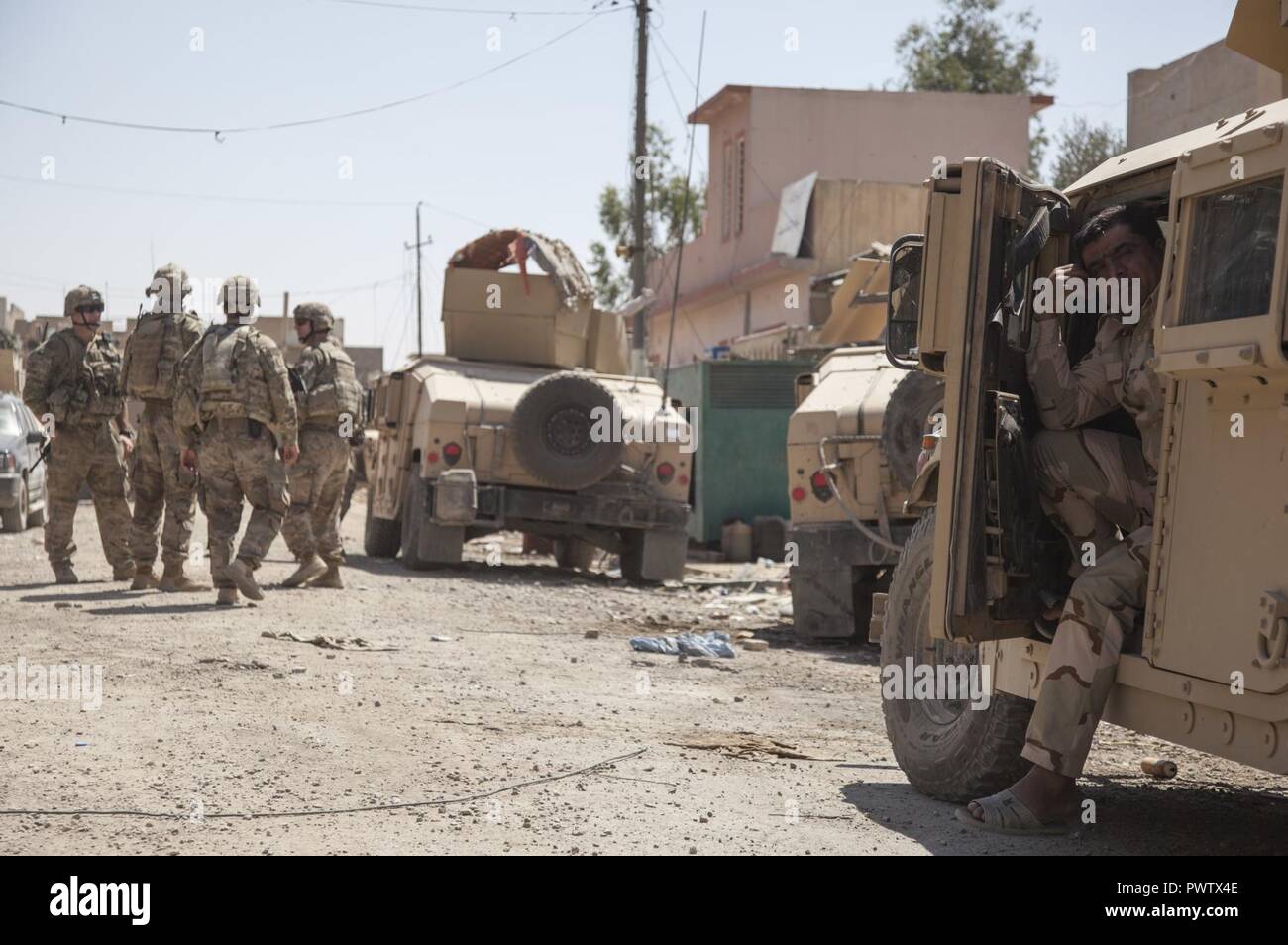 An Iraqi security forces member sits in a Humvee after establishing a ...