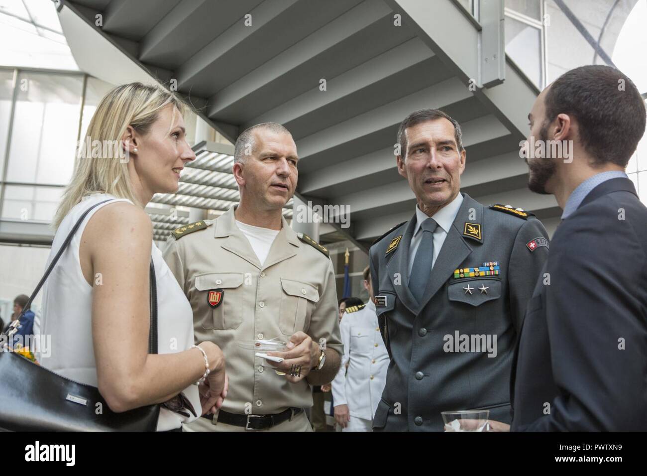 Swiss Maj. Gen. Peter Wanner, naval attaché, speaks with guests during ...