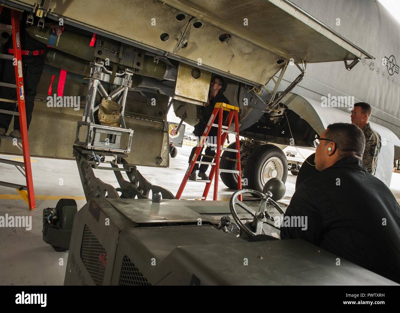 Members of the 5th Aircraft Maintenance Global Strike Challenge team load an inert GBU-38 ...