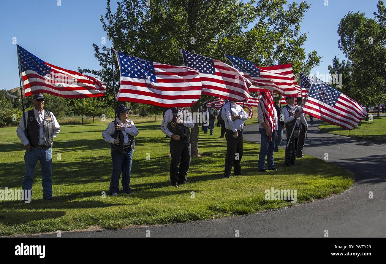 Members of the Patriot Guard Riders line the roadway of the procession ...