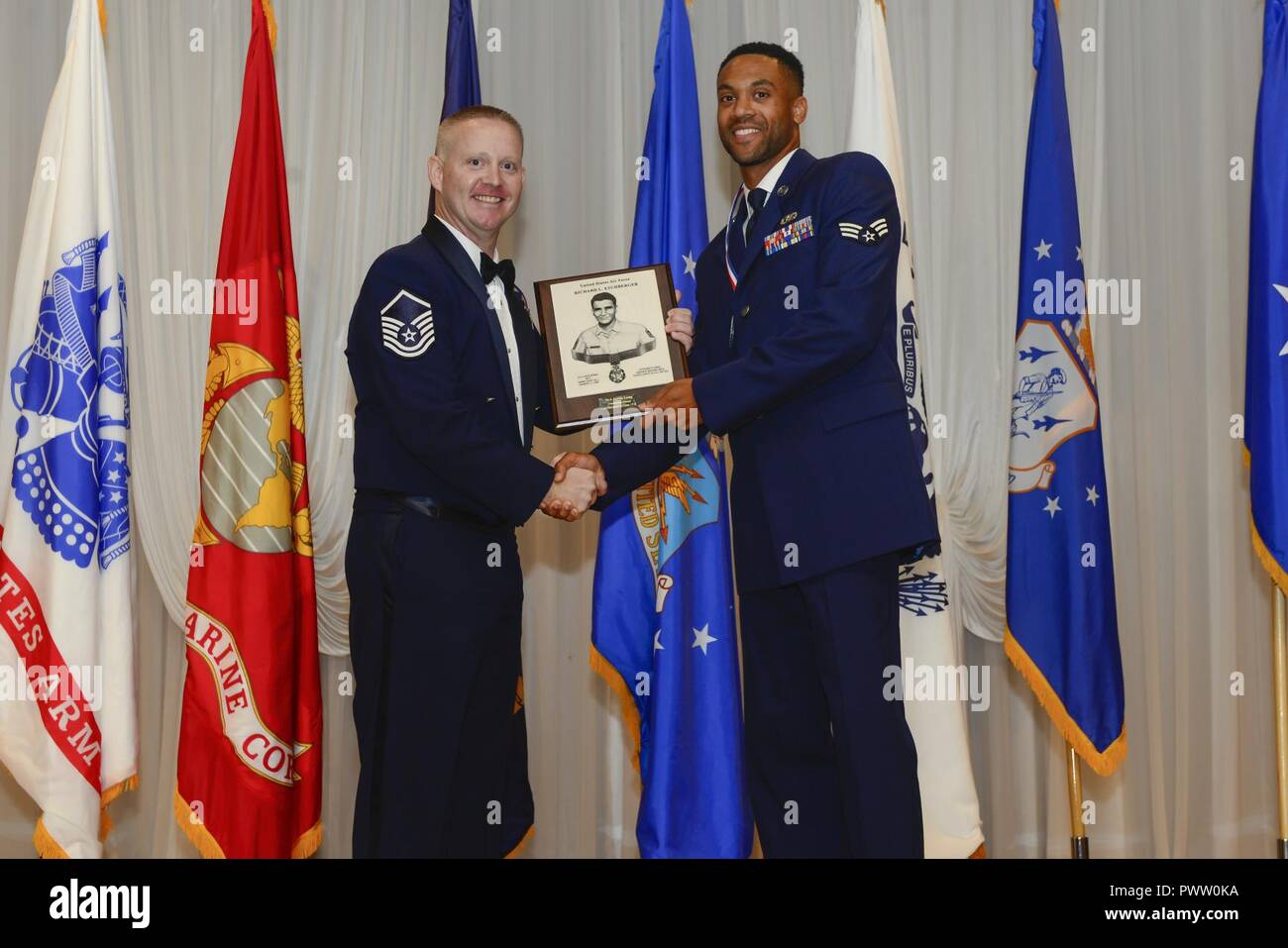 U.S. Air Force Senior Airman Justin Long receives his leadership award ...