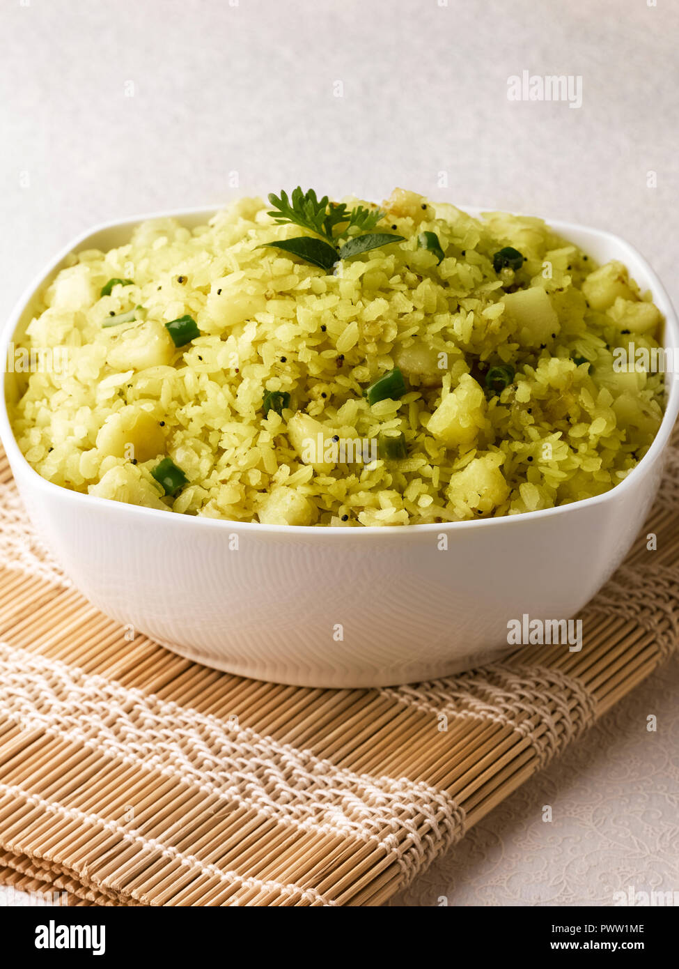 BATATA POHA made from puffed rice flakes, potato and onions. served ...