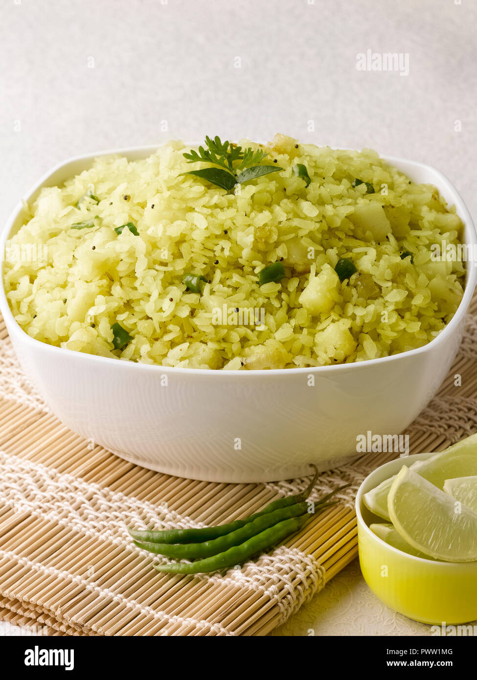 BATATA POHA made from puffed rice flakes, potato and onions. served ...